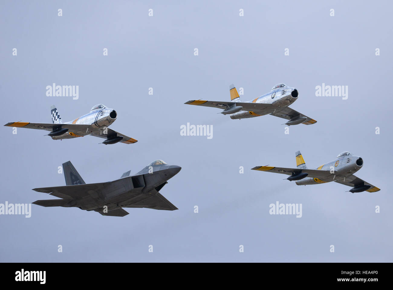 Three F-86 Sabres and a U.S. Air Force F-22 Raptor fly in formation ...