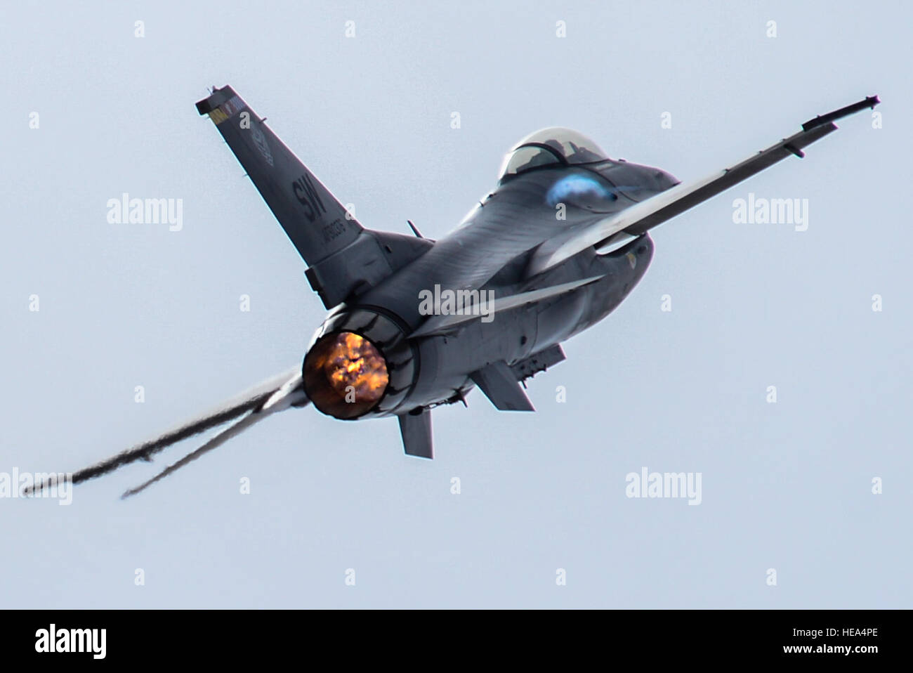 An F-16D Fighting Falcon aircraft engages its afterburner during ...