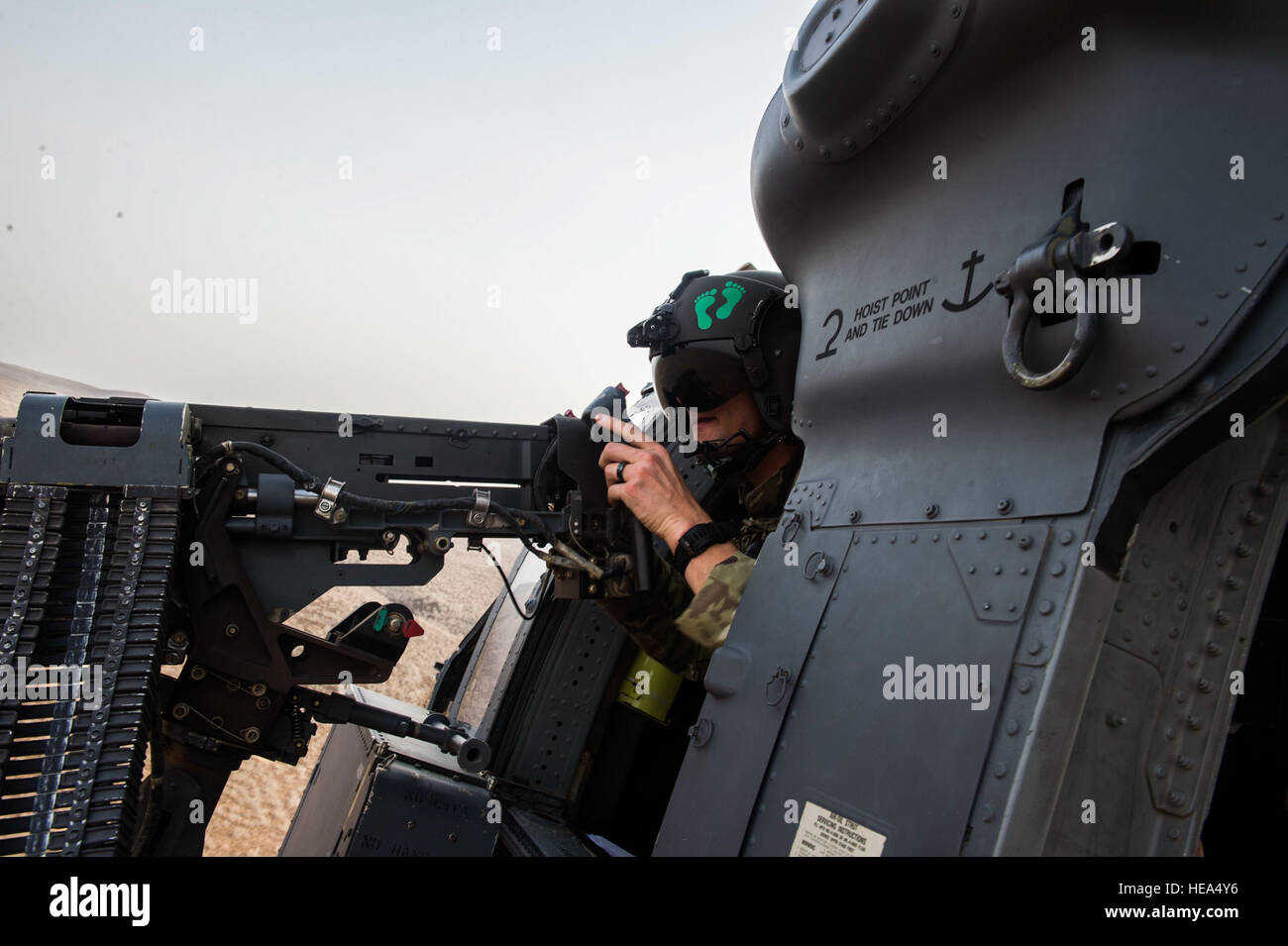 An aerial gunner with the 303rd Expeditionary Rescue Squadron looks out ...