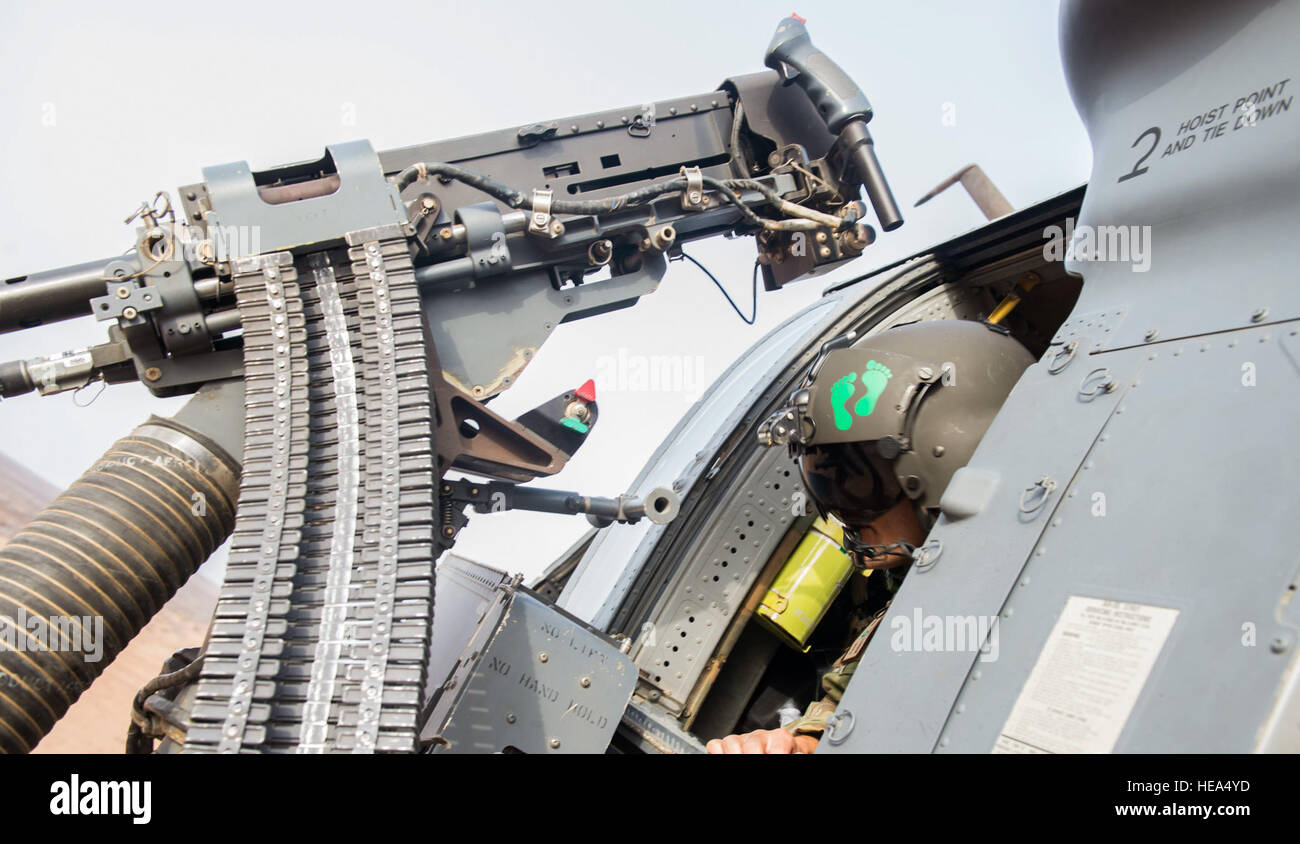 An aerial gunner with the 303rd Expeditionary Rescue Squadron looks out ...