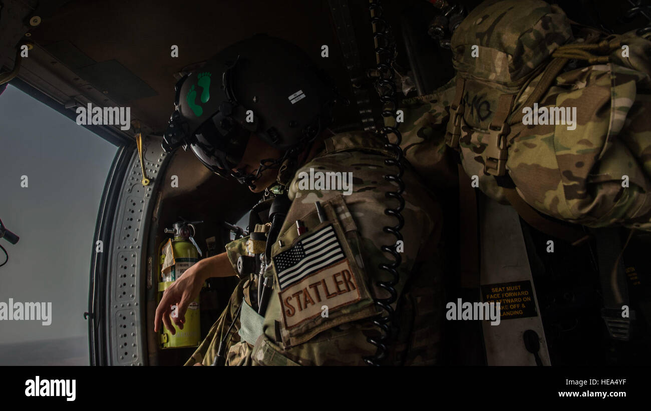 An aerial gunner with the 303rd Expeditionary Rescue Squadron looks out ...