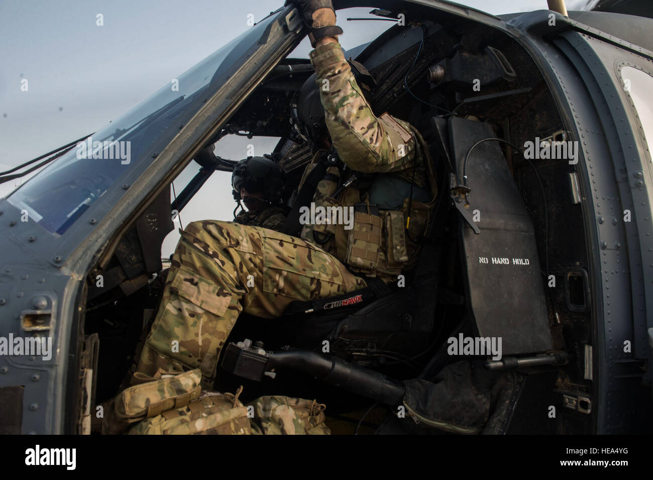 A pilot with the 303rd Expeditionary Rescue Squadron looks out from his ...