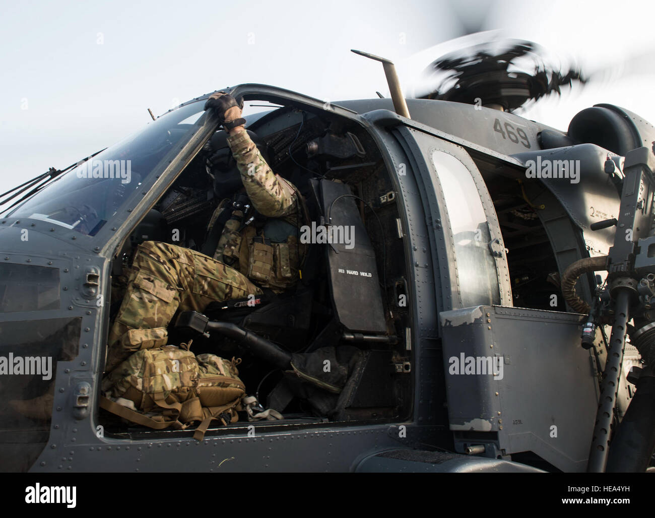 A pilot with the 303rd Expeditionary Rescue Squadron looks out from his ...