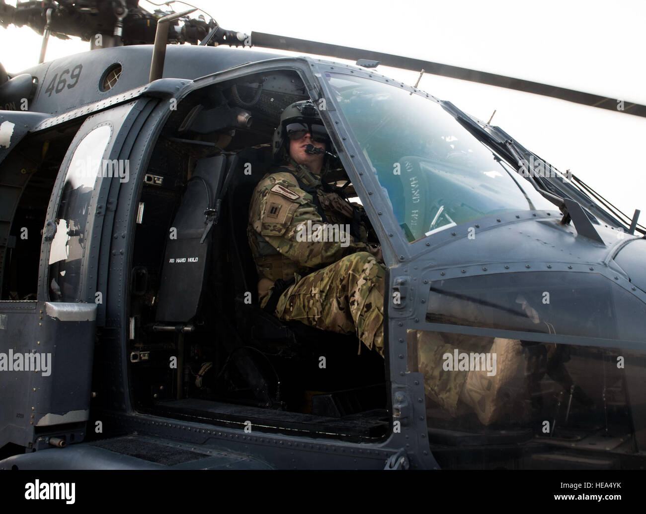 A pilot with the 303rd Expeditionary Rescue Squadron looks out from his ...