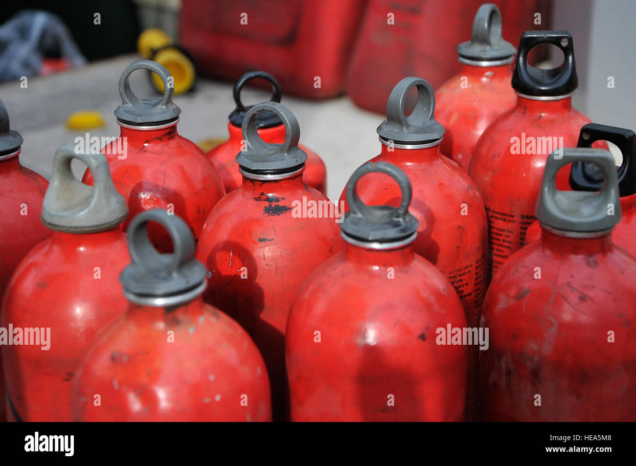 Fuel bottles containing chainsaw mix and bar oil are prepared before ...