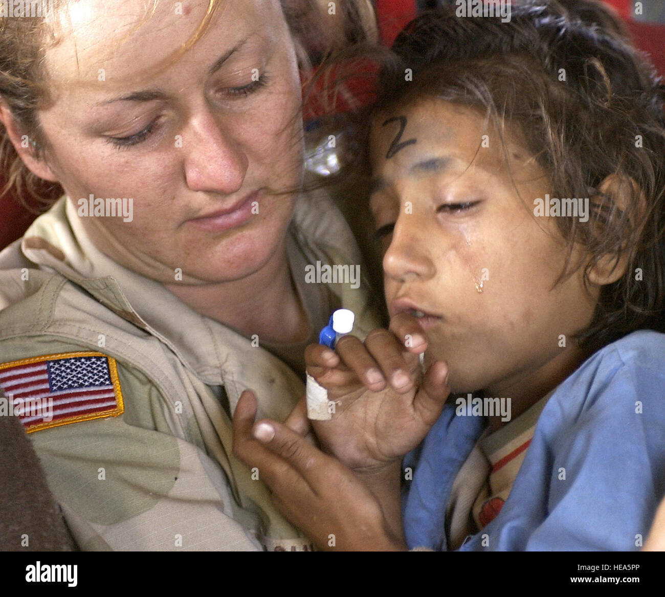 U.S. Army Sgt. Kornelia Rachwal comforts a young Pakistani girl being ...