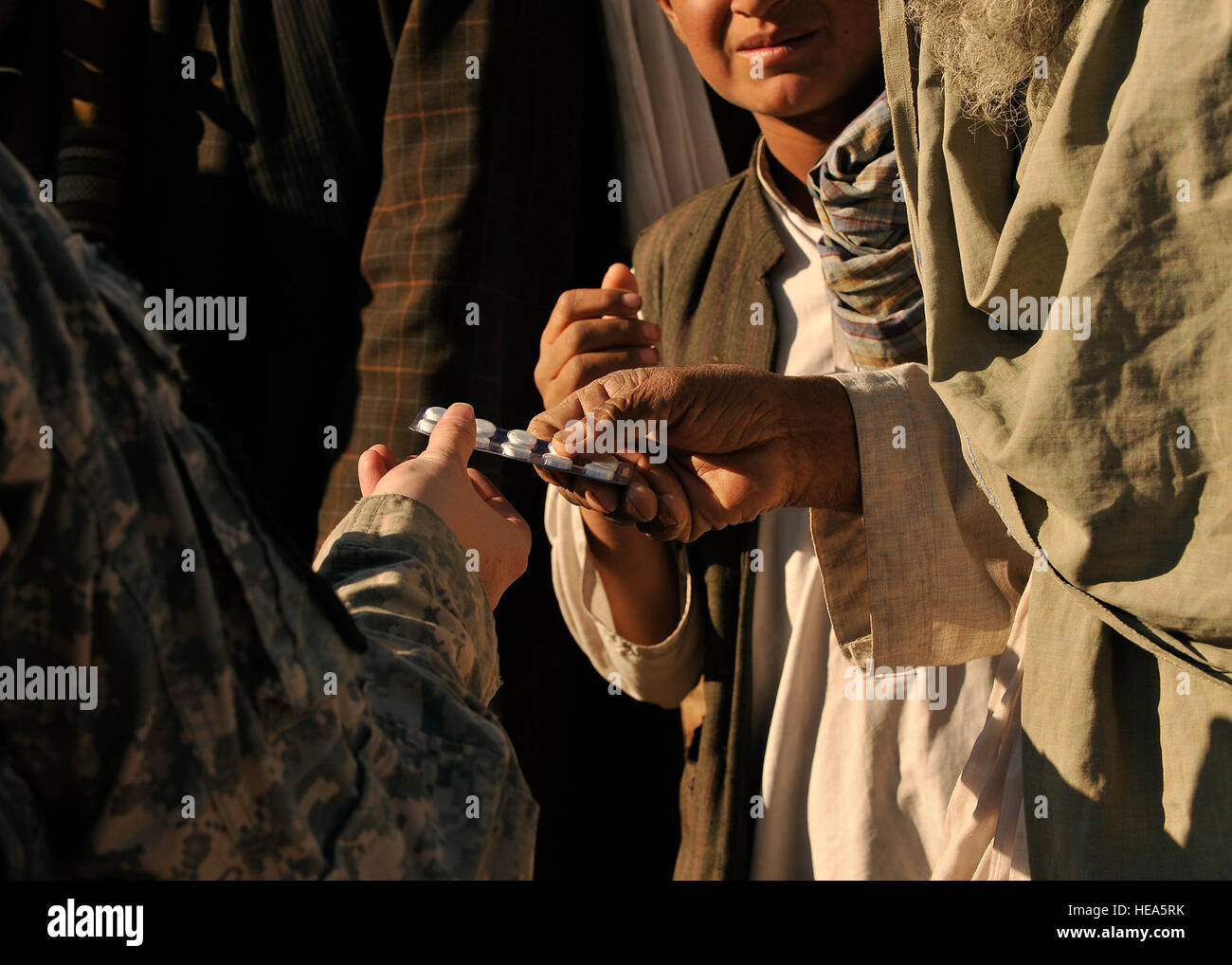 Afghan children receive medicine during a medical outreach in a Kuchi ...