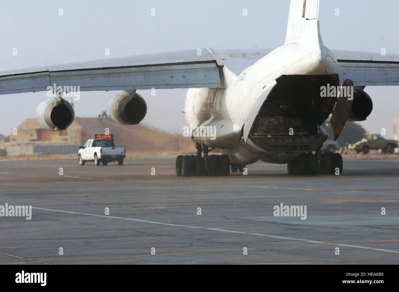 ALI AIR BASE, Iraq -- Tech. Sgt. John Livermon escorts an Antonov An-12 ...
