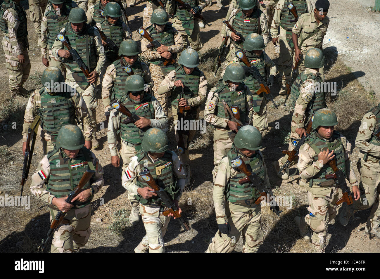 Iraqi army soldiers march en route to conduct tactical training with an ...