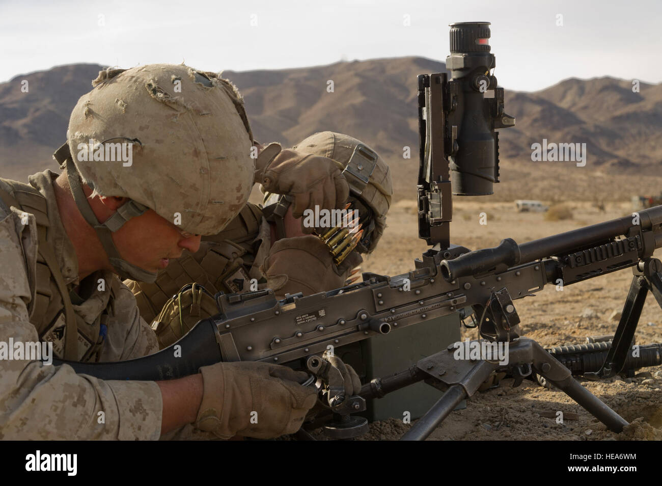 U.S. Marines load an M240E machine gun while participating in a ...