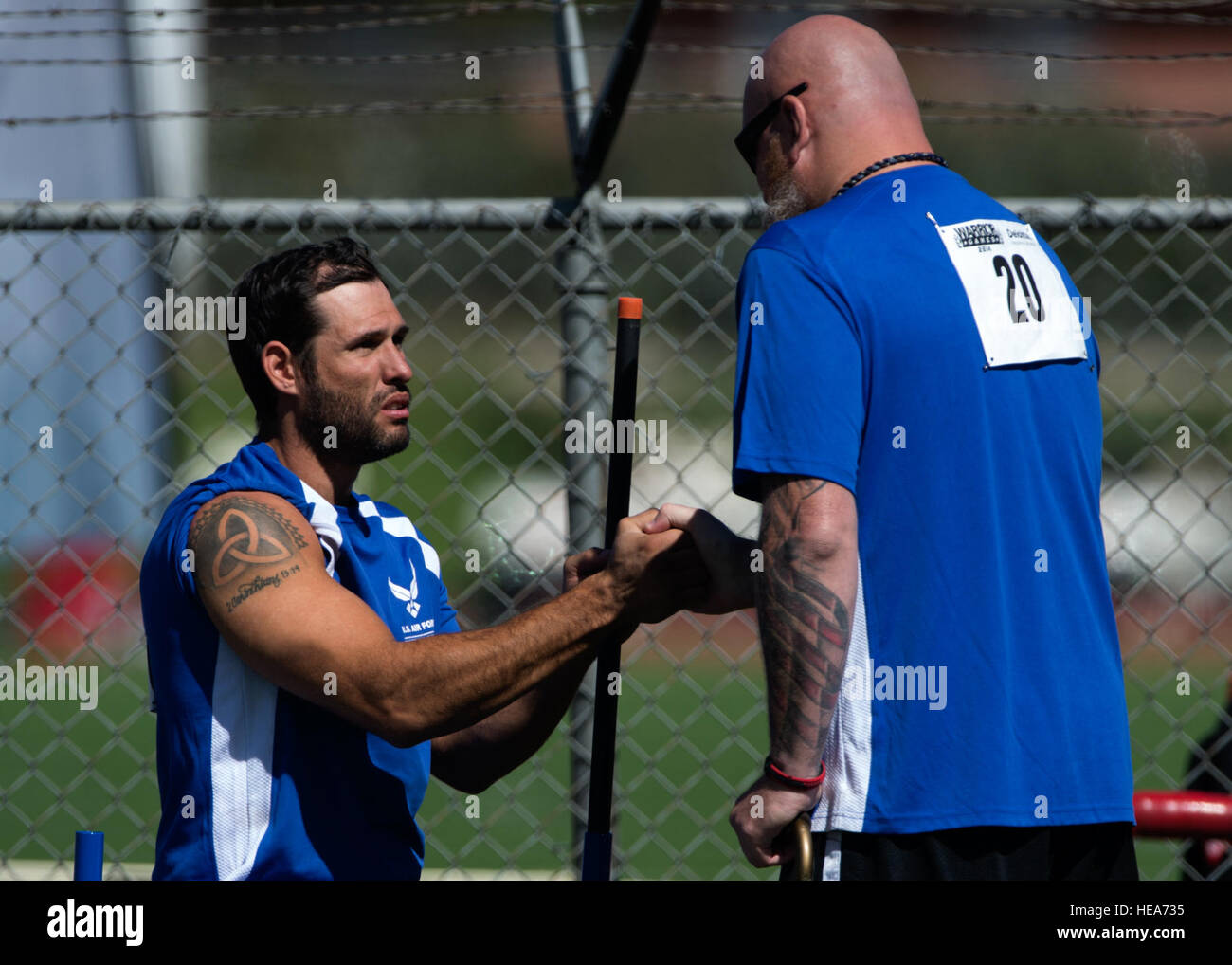 Air Force athlete Keith Sekora (right) wishes Ryan Pinney (left) luck ...