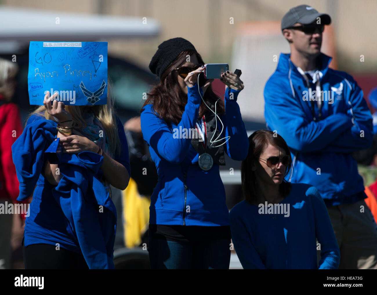 Megan Pinney (center), wife of Air Force athlete Ryan Pinney, watches ...