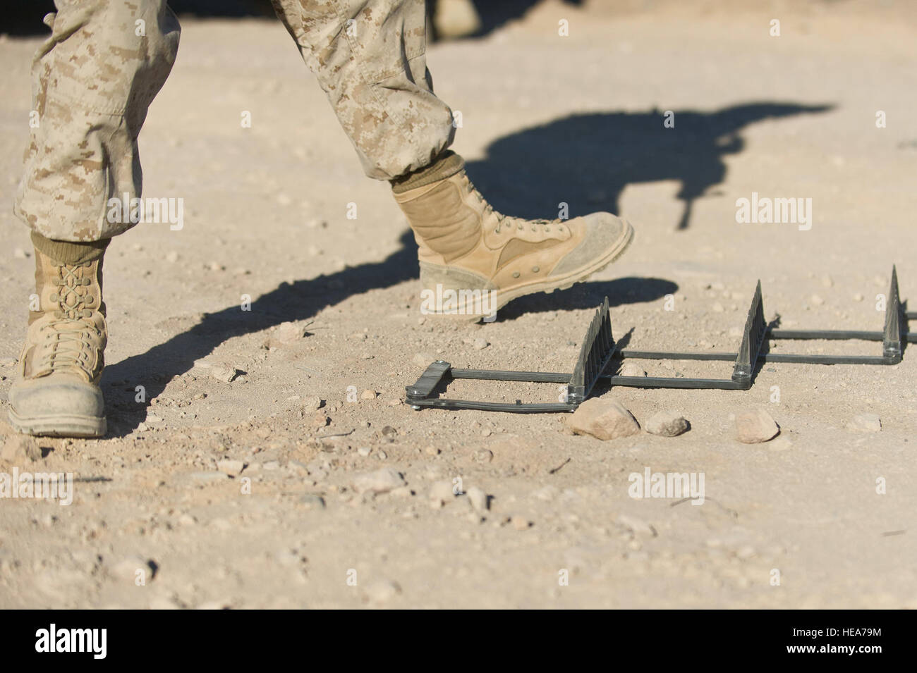 A U.S. Marine puts down a tire deflation device during Integrated ...