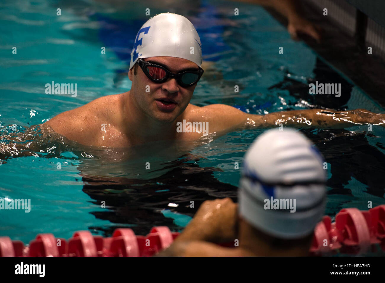 Air Force athlete Jason Hoover talks with a teammate during warmups at ...
