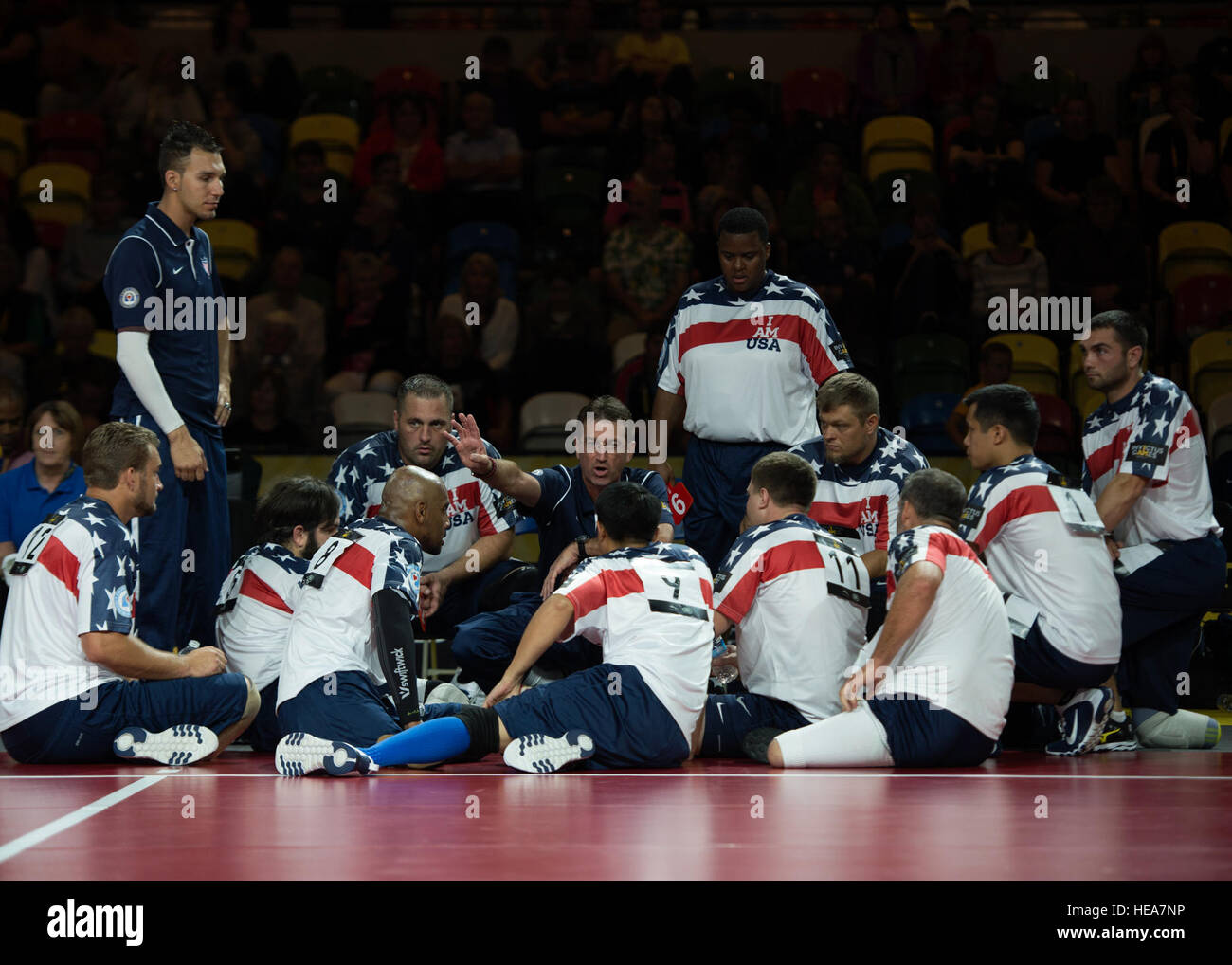 Members of the U.S. sitting volleyball team discuss the game during a ...