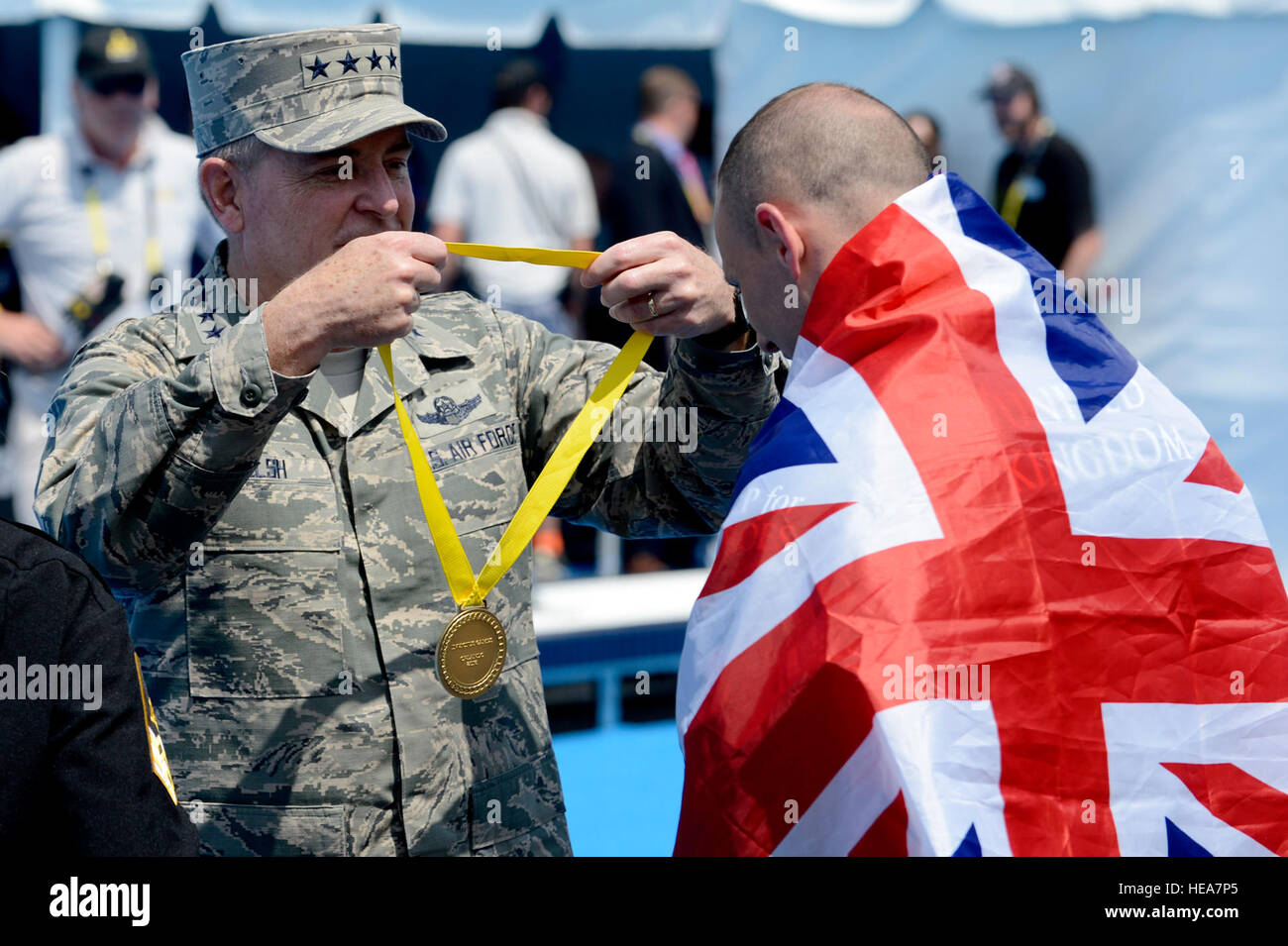U.S. Air Force General Mark A. Welsh III, present the gold medal to a ...