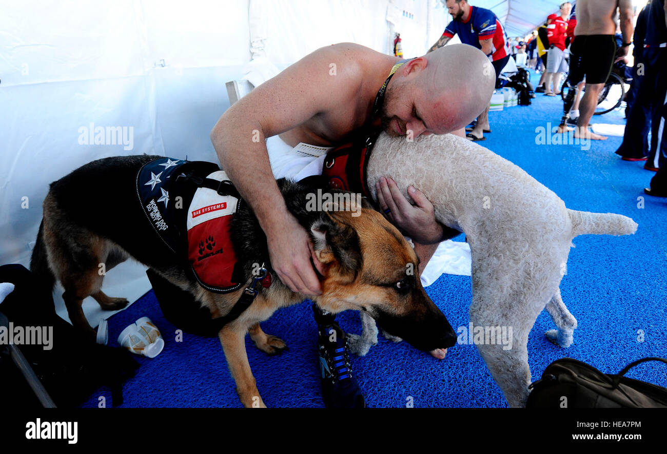 Retired Naval Aircrewman Brett Parks, hugs service dogs belonging to ...