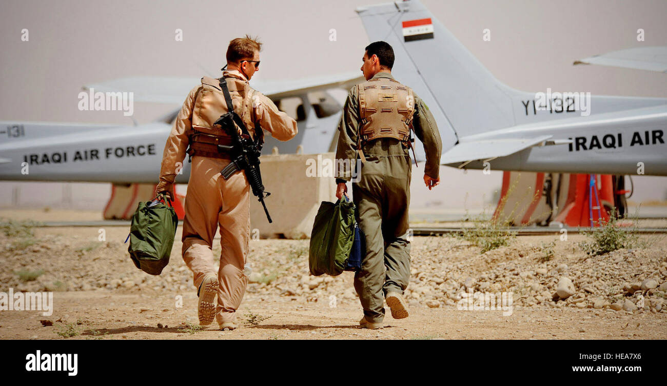 Capt. Jamie Riddle and an Iraqi Flight Instructor School student walk ...