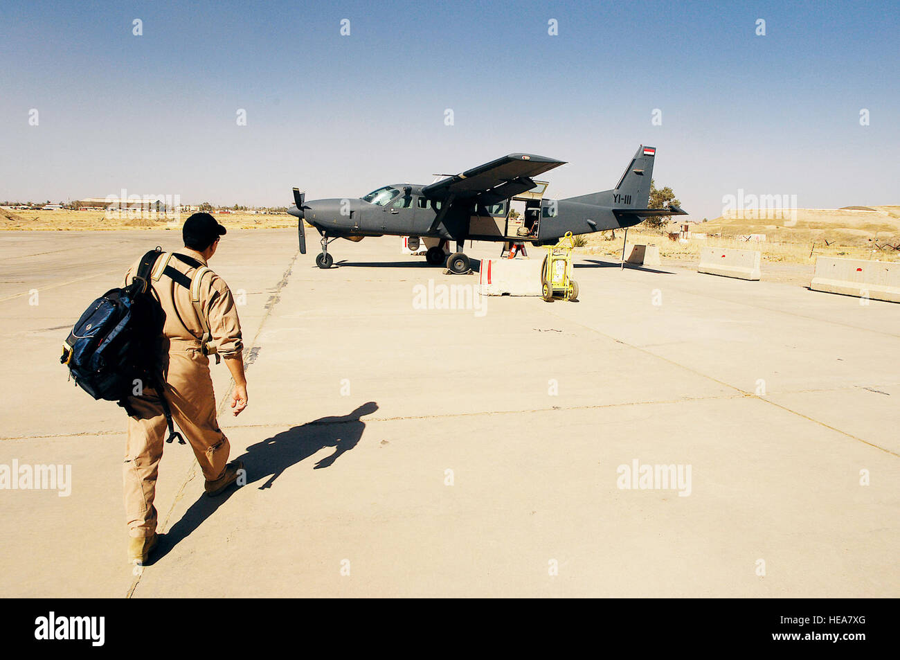 An Iraqi pilot walks to a Iraqi AC-208 Caravan for a training mission ...