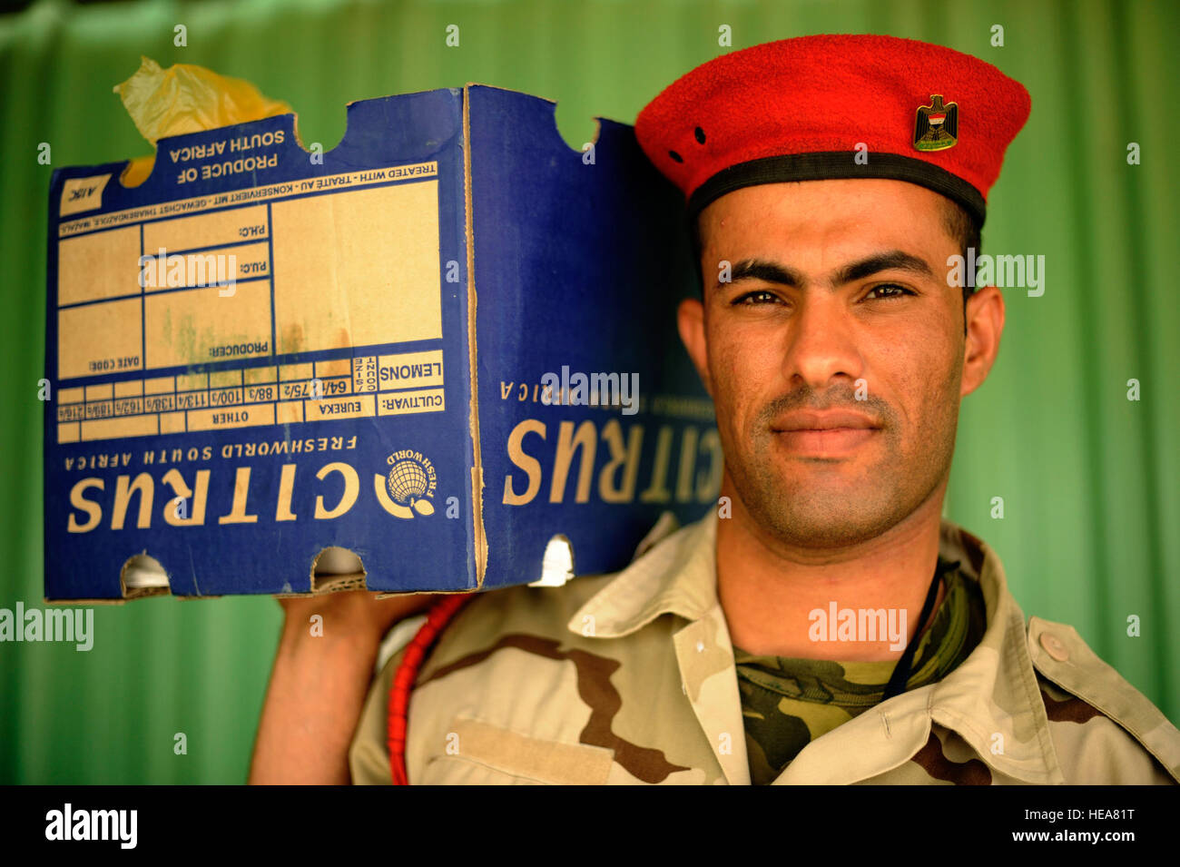 An Iraqi soldier carries a box of food from an Iraqi dining facility ...