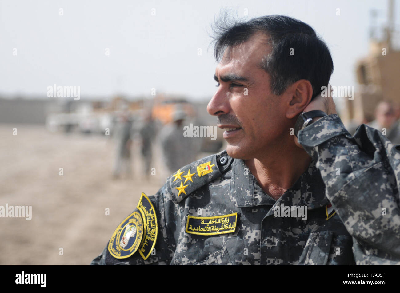 An Iraqi national police officer stops to think about which items to ...