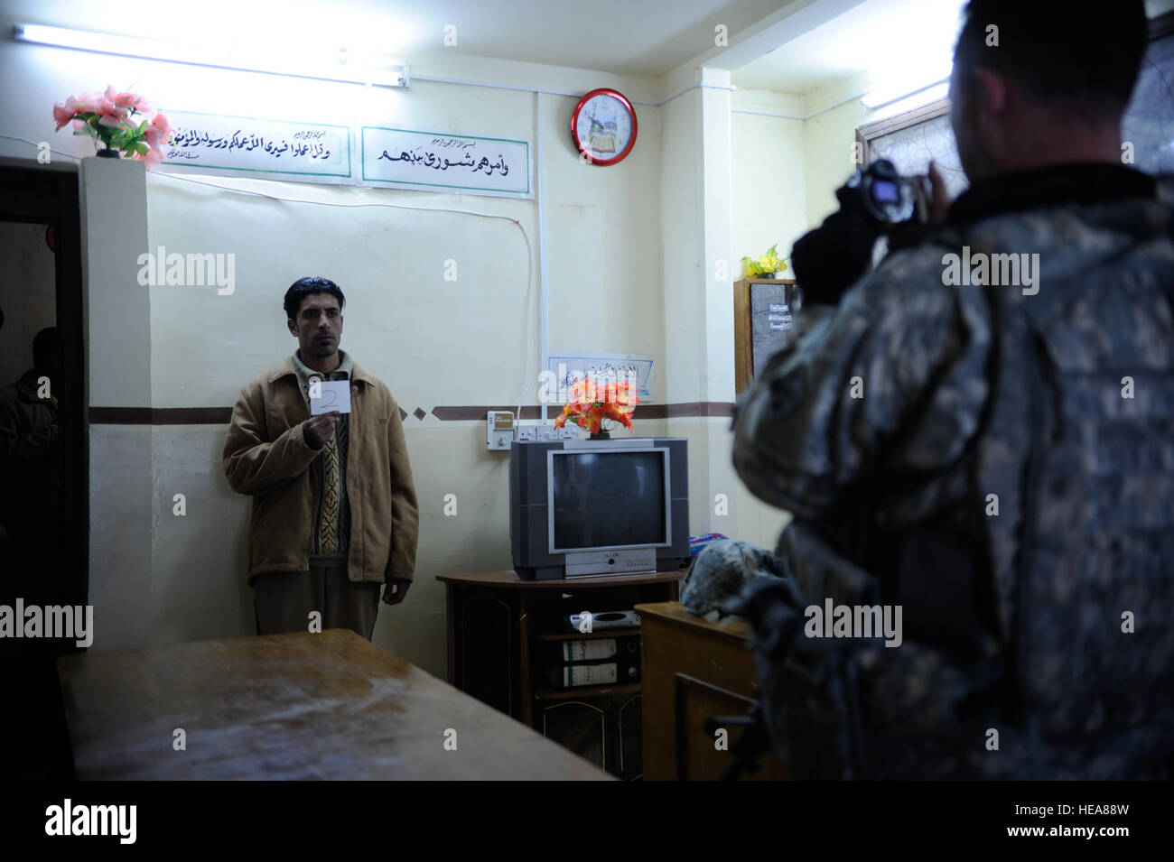 An Iraqi man gets his photo taken by 1st Lt. Tyrone Rankin, 1st ...