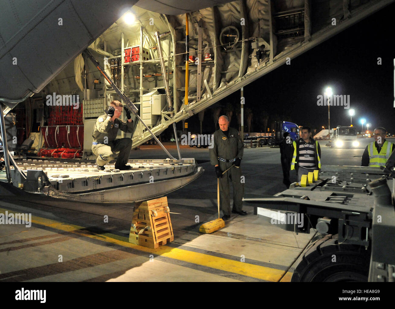 U.S. Air Force personnel unload fire retardant from a C-130J Super ...