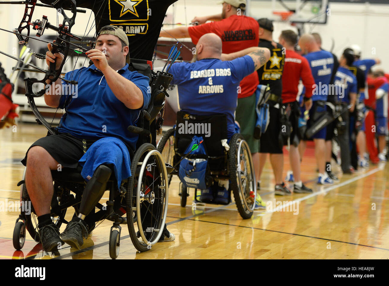 Air Force Athlete Seth Pena (left) competes in archery during the 2014 ...