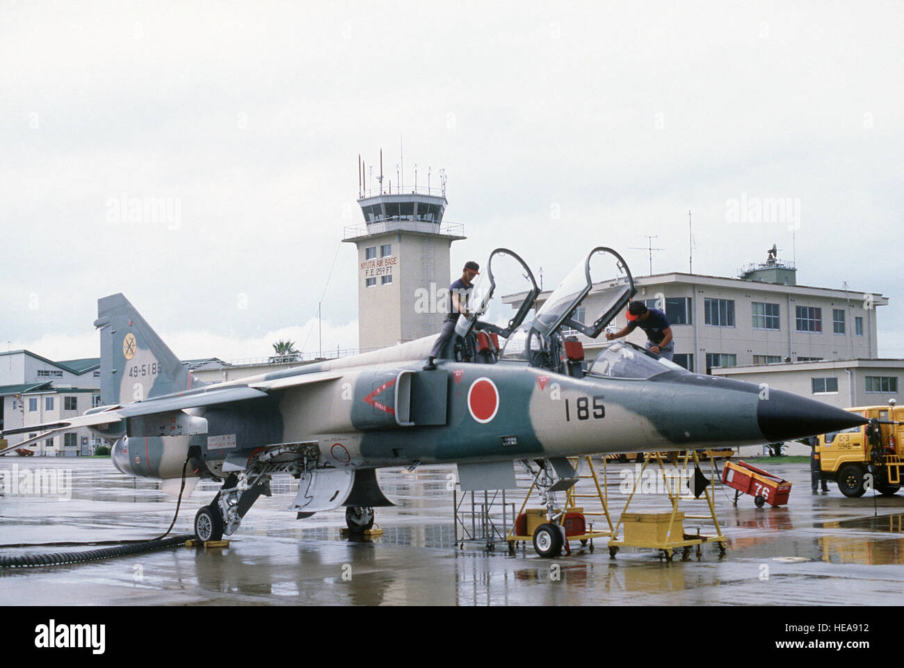 Japanese ground crewmen work on the canopies of a Japanese T-2 aircraft ...