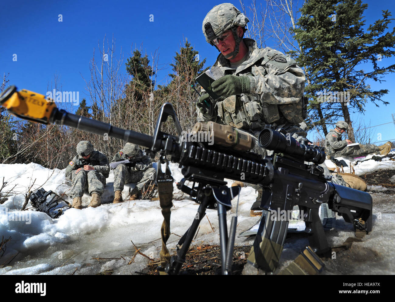 A U.S. Army airborne infantryman navigates a daytime land course at ...