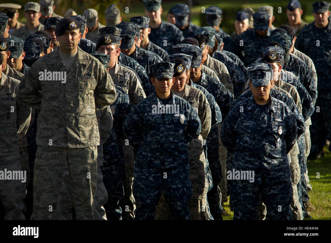 Service members and civilian first responders bow their heads in pray ...