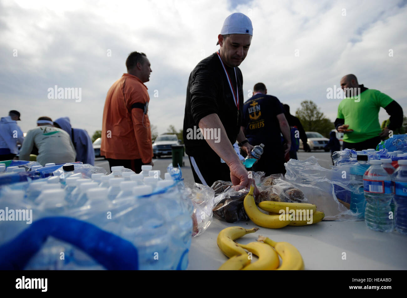 Runners eat snacks and drink water after completing the Joint Base ...