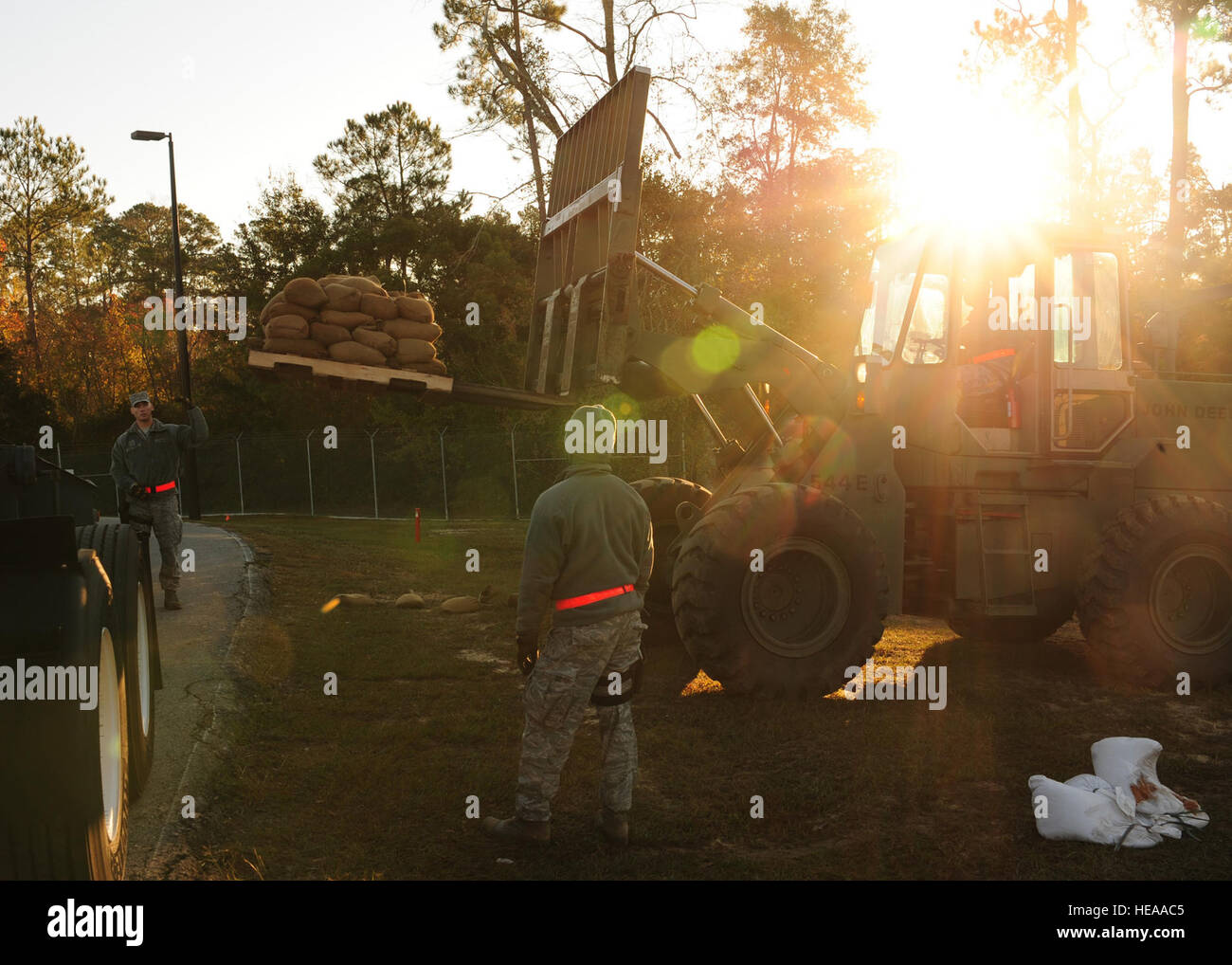Airmen from the 628th Security Forces Squadron prepare sandbags to ...