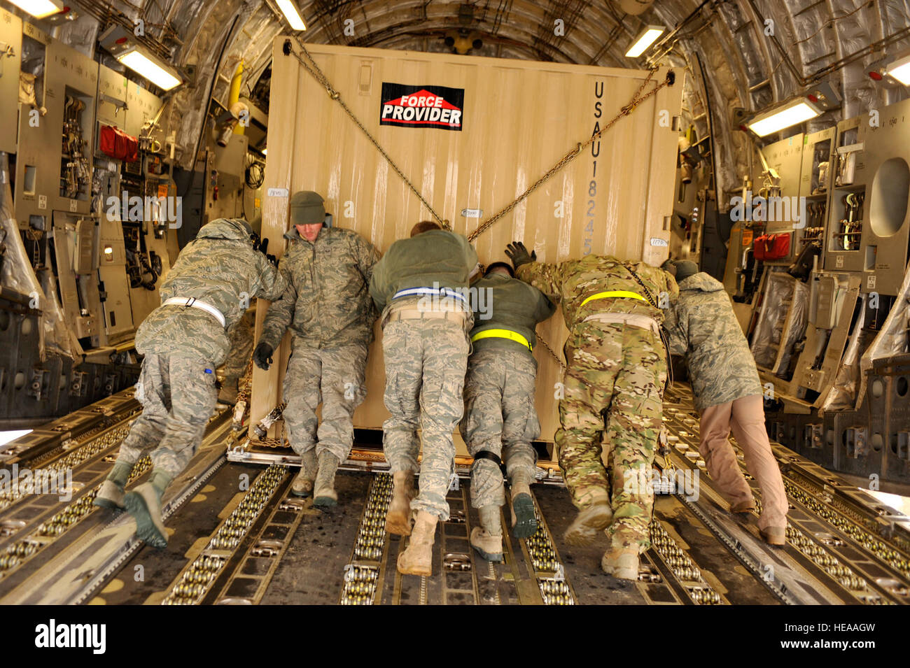 Members of the 455th Expeditionary Aerial Port Squadron load equipment ...