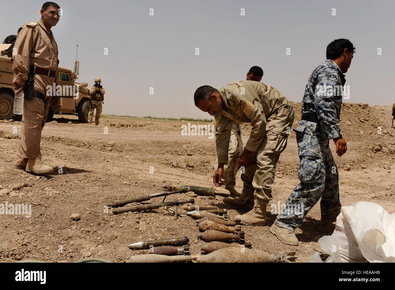 Iraqi police and Iraqi soldiers work together to unload recovered ...