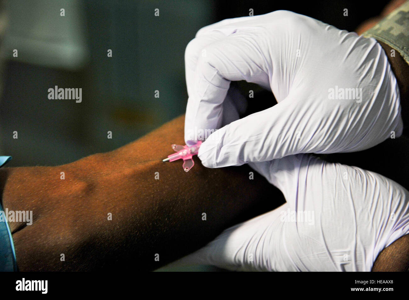 A U.S. Army medical nurse prepares a patient for an intravenous ...