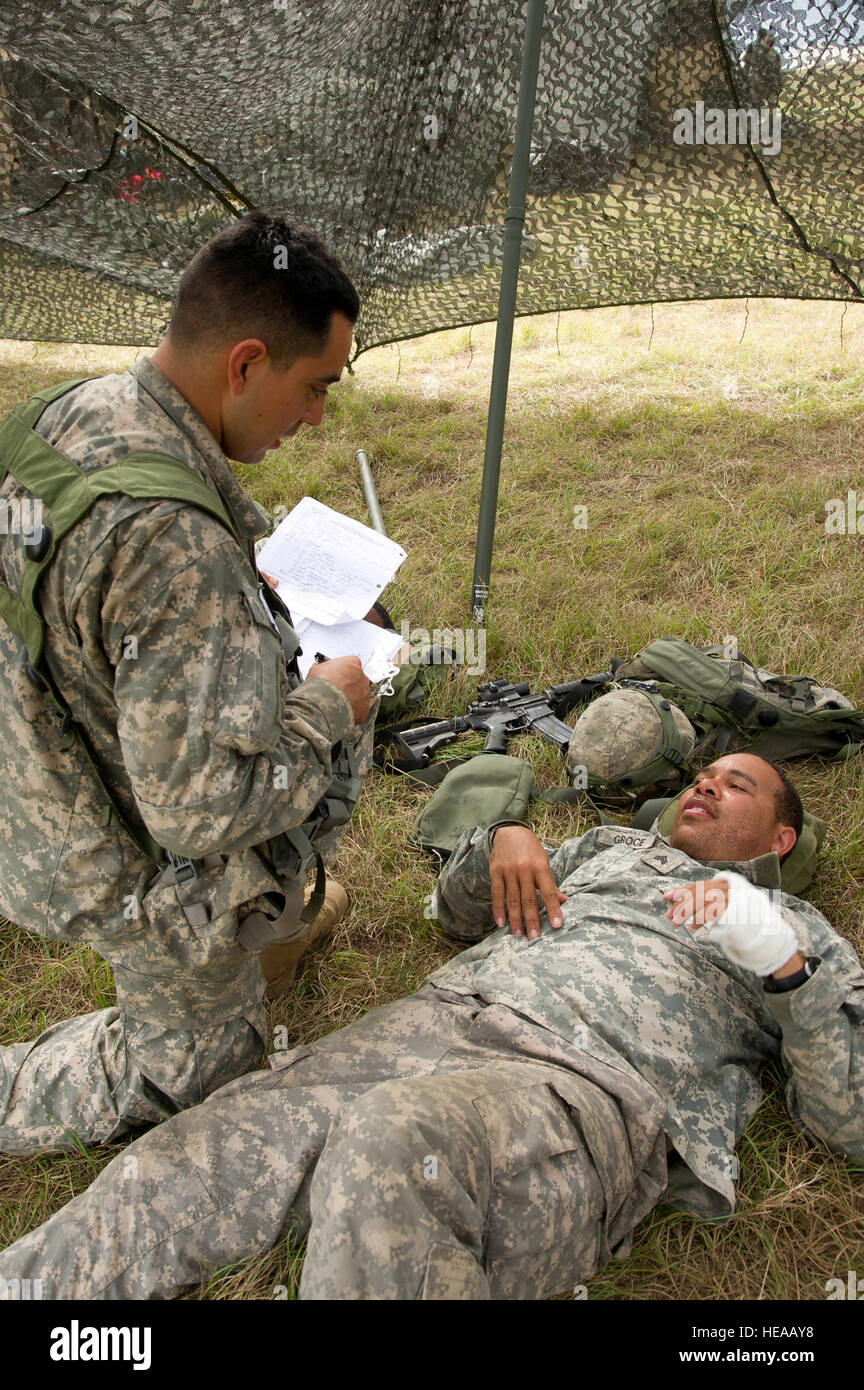 U.S. Army Spc. Julio Pesqueira, Charlie Company, checks paperwork on ...