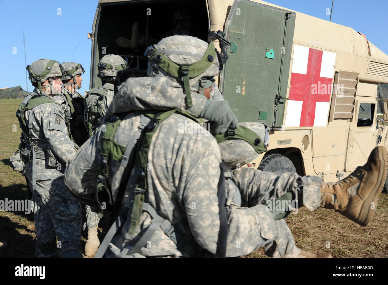 U.S. Army medics carry a wounded soldier from a field ambulance into ...