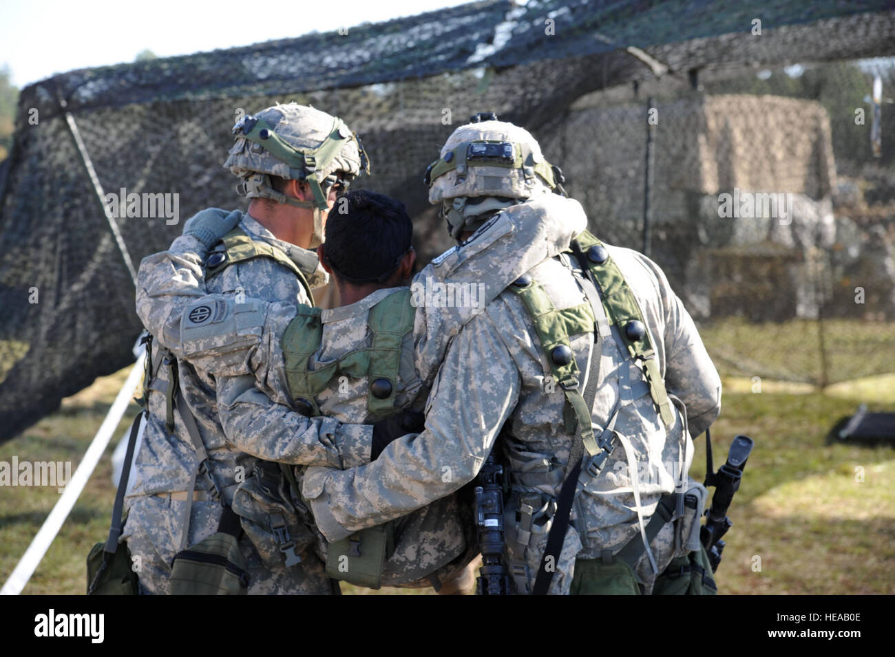 U.S. Army medics carry a wounded soldier into Charlie Company Meds ...