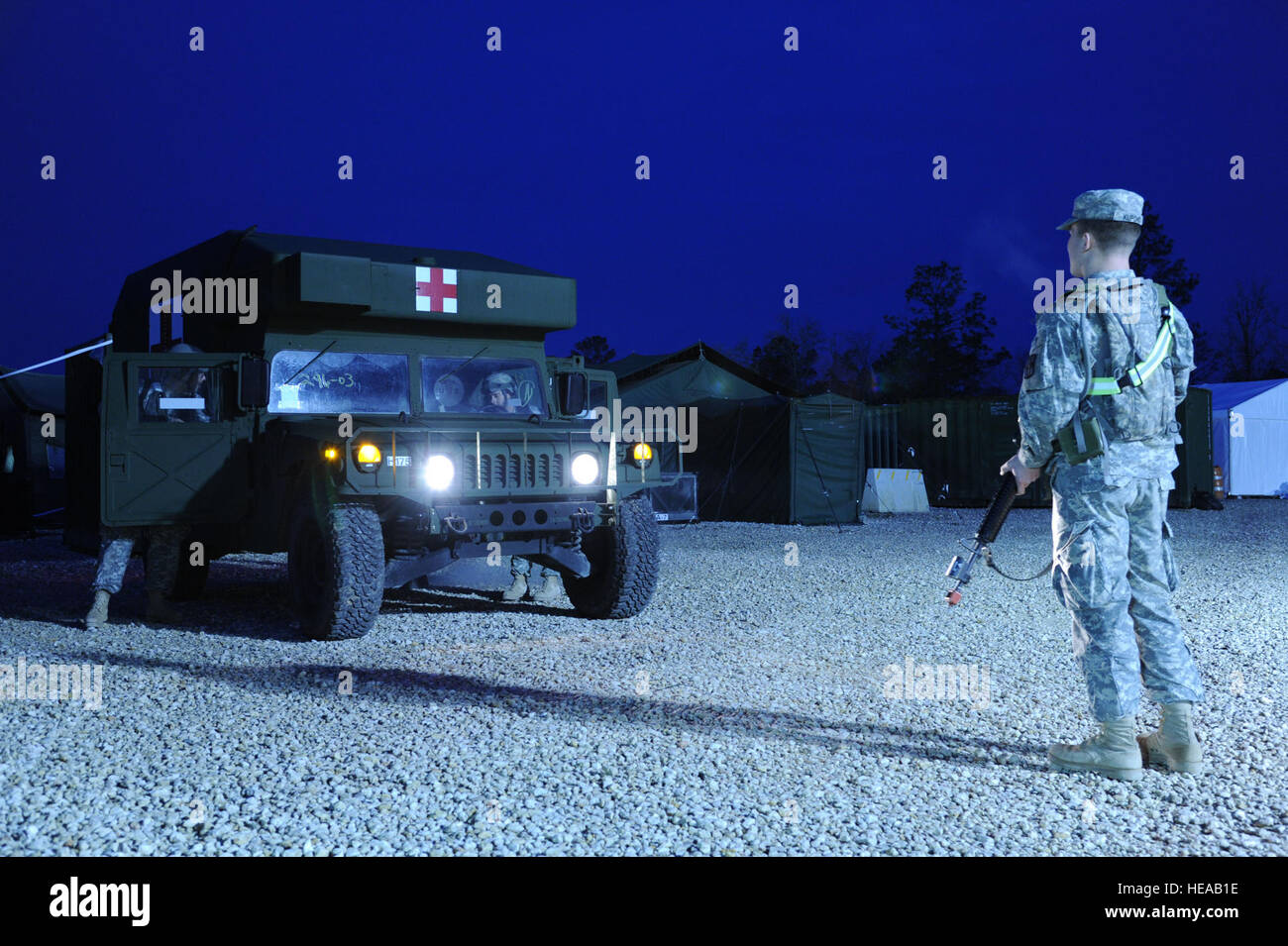 A U.S. Army soldier stands ready to guide an ambulance into the triage ...