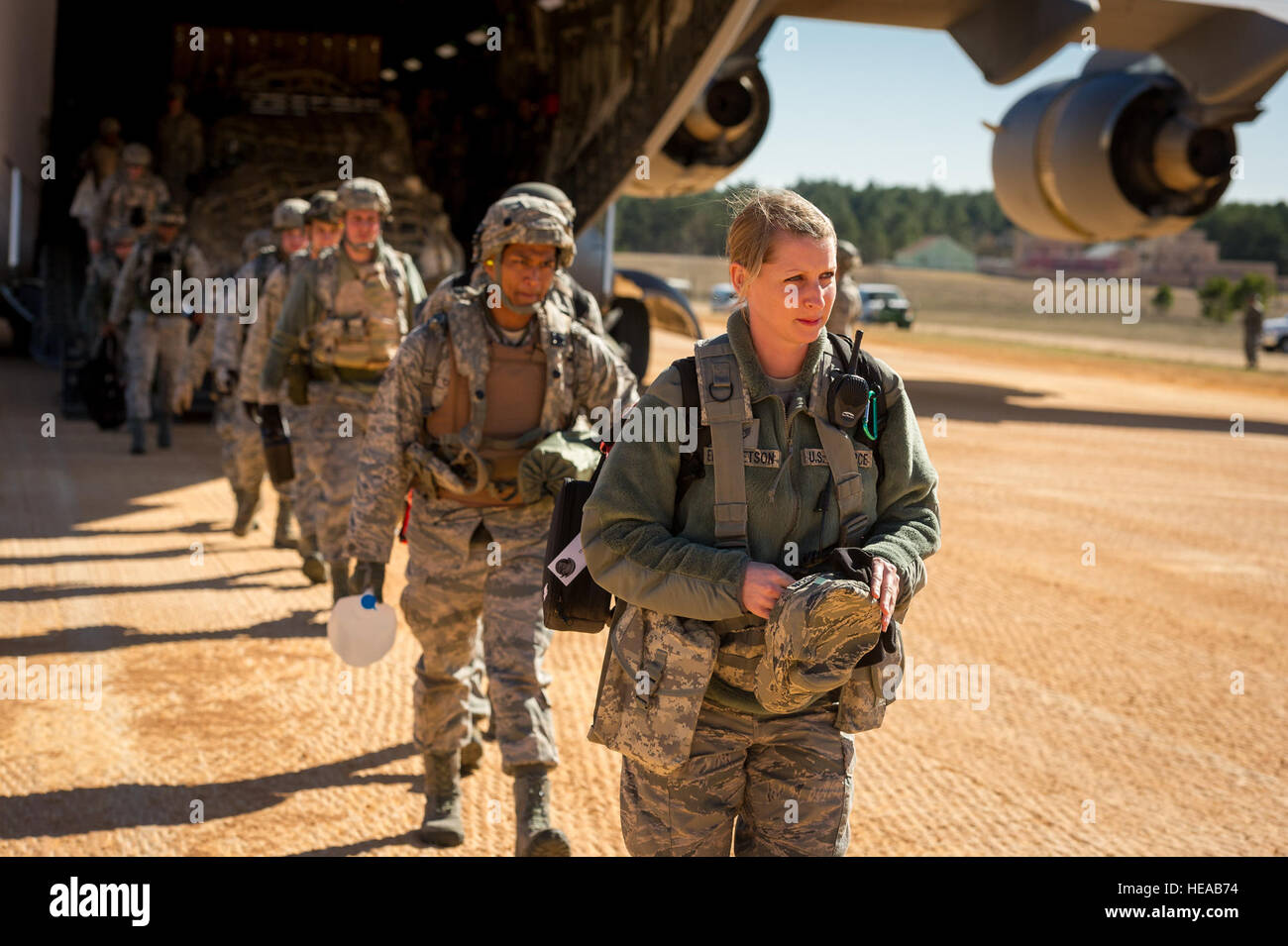 U.S. Air Force Airmen perform an engine running offload from the back ...