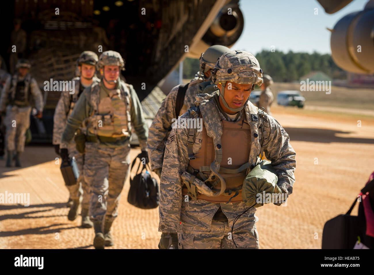 U.S. Air Force Airmen perform an engine running offload from the back ...