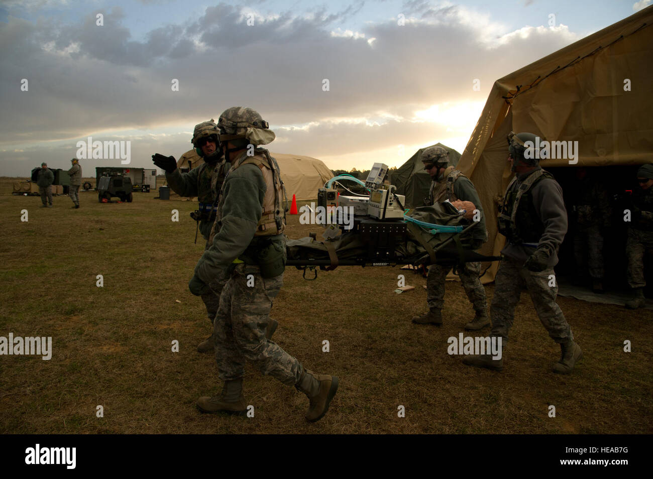 Air Force personnel carry a simulated litter patient during a field ...