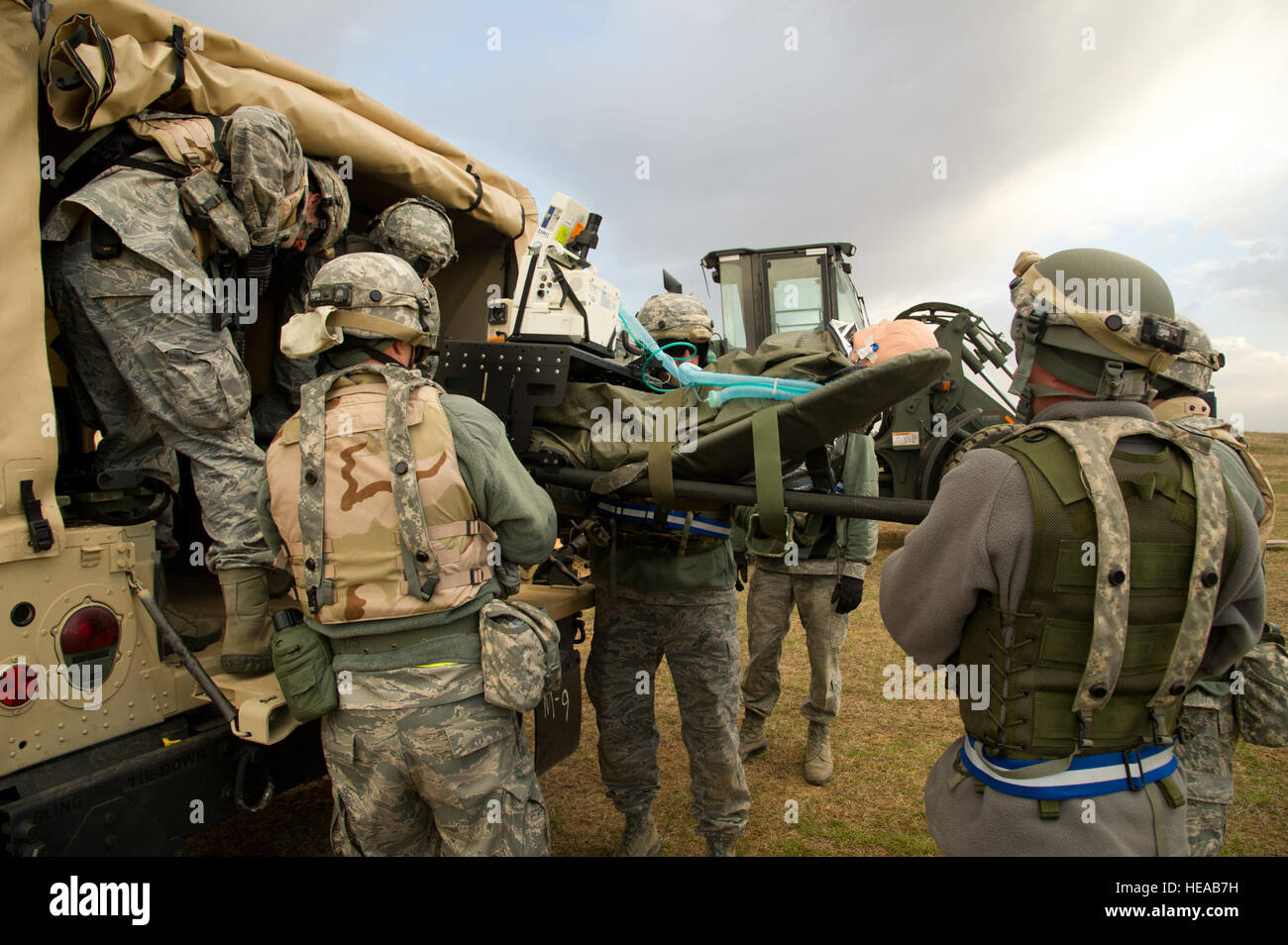 U.S. Air Force Airmen load a simulated patient into a Humvee during a ...