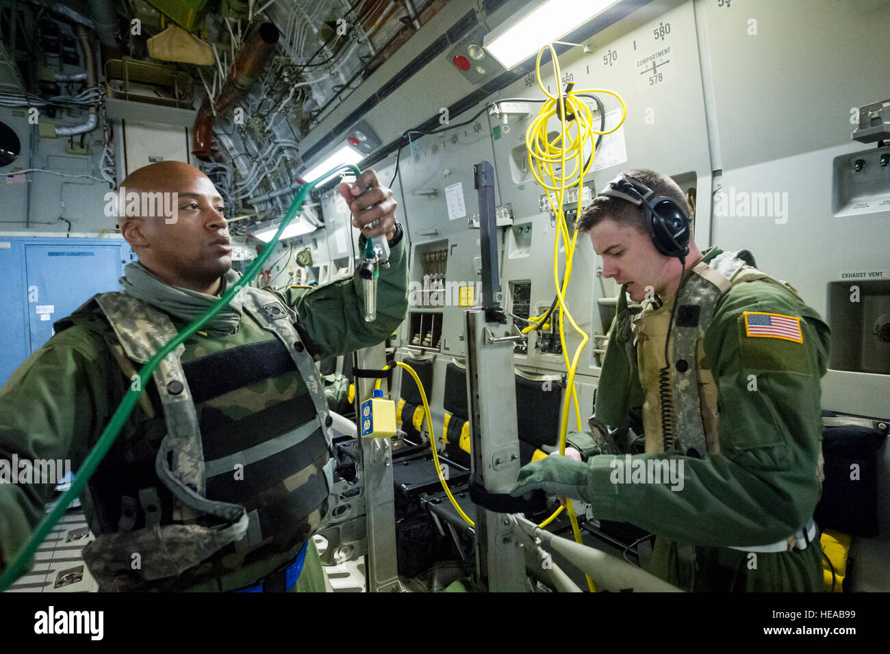 Air Force aeromedical personnel secure power and oxygen connections to ...