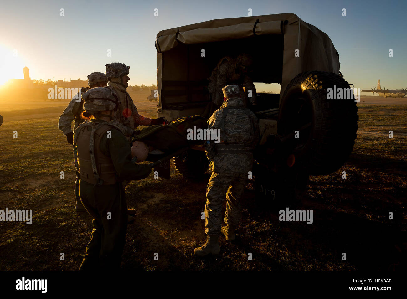 Airmen load simulated patient litters into Humvees at Joint Readiness ...