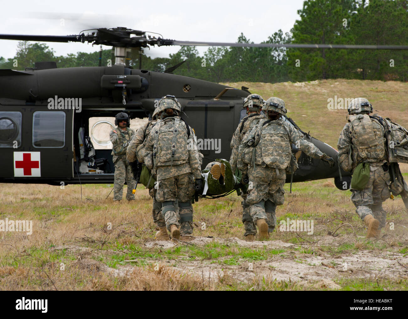 U.S. Army Soldiers prepare to load a simulated patient onto a UH-60 ...