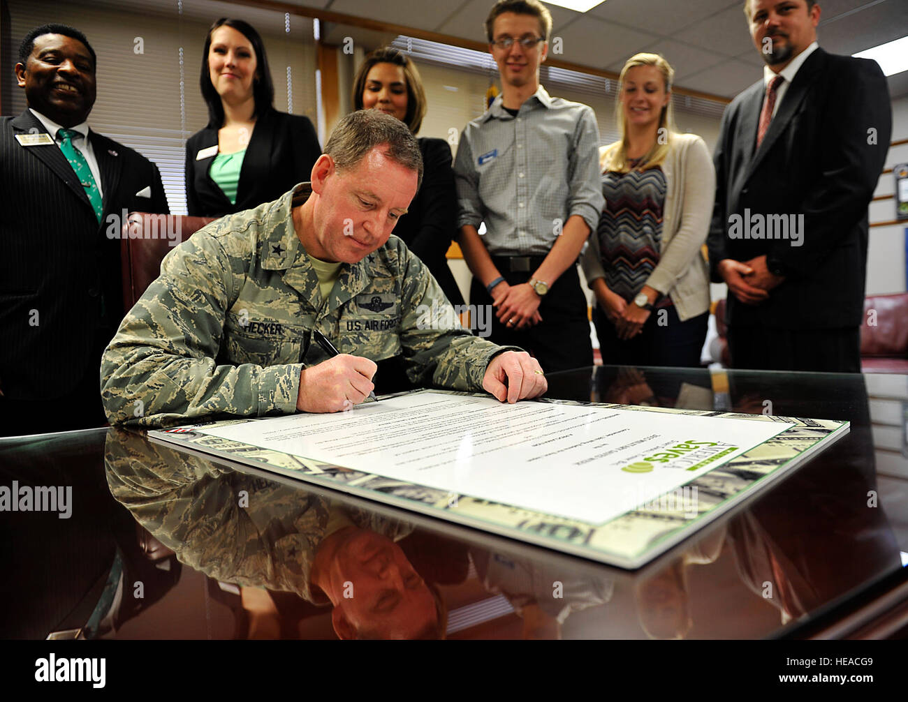 U.S. Air Force Brig. Gen. James Hecker, 18th Wing commander, signs the ...