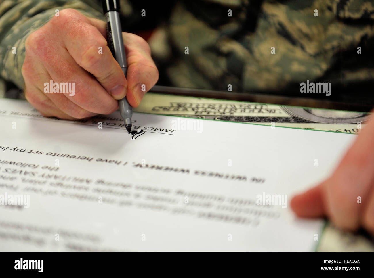 U.S. Air Force Brig. Gen. James Hecker, 18th Wing commander, signs the ...