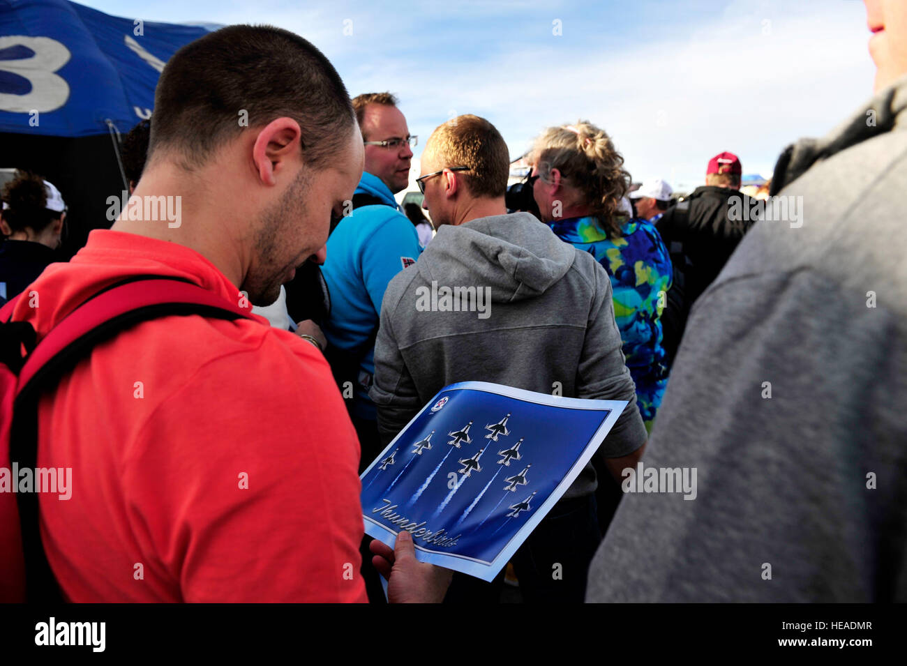 Admiring fans wait to get their posters autographed during a ...